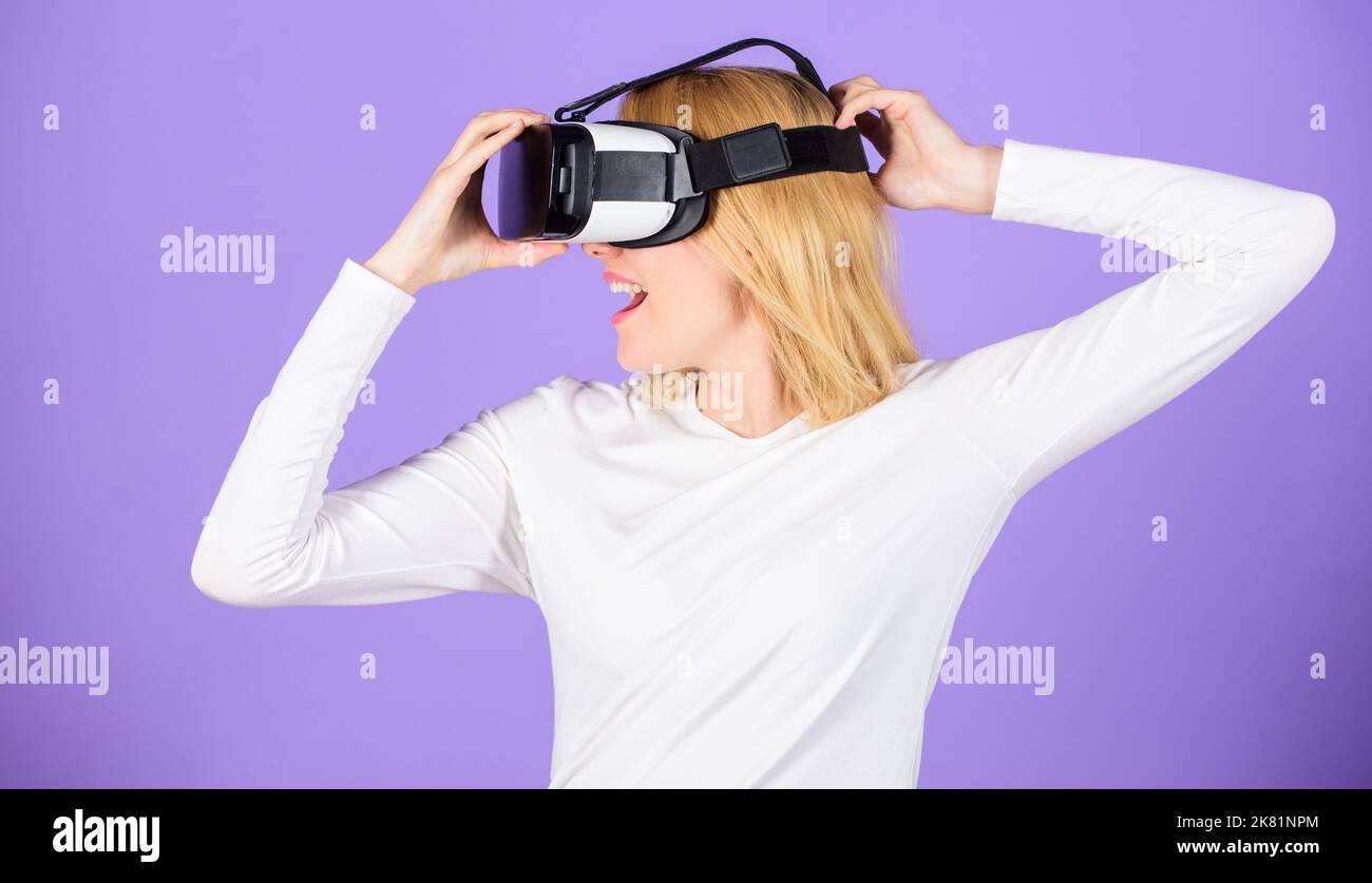 Explore virtual reality. Woman hold vr headset glasses violet ...