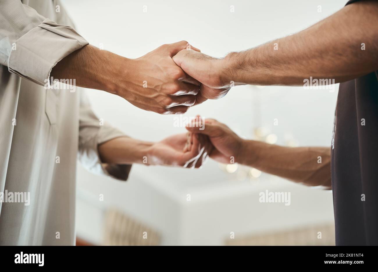 Bonding with family members. two muslim men holding hands in prayer ...