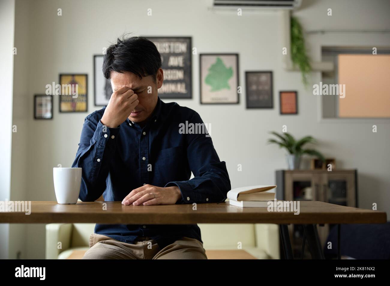 Tired Japanese man at home Stock Photo - Alamy