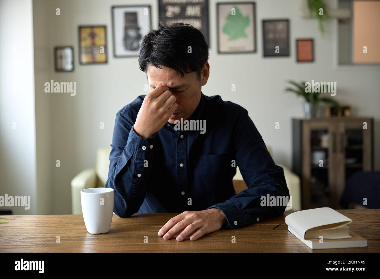 Tired Japanese man at home Stock Photo - Alamy