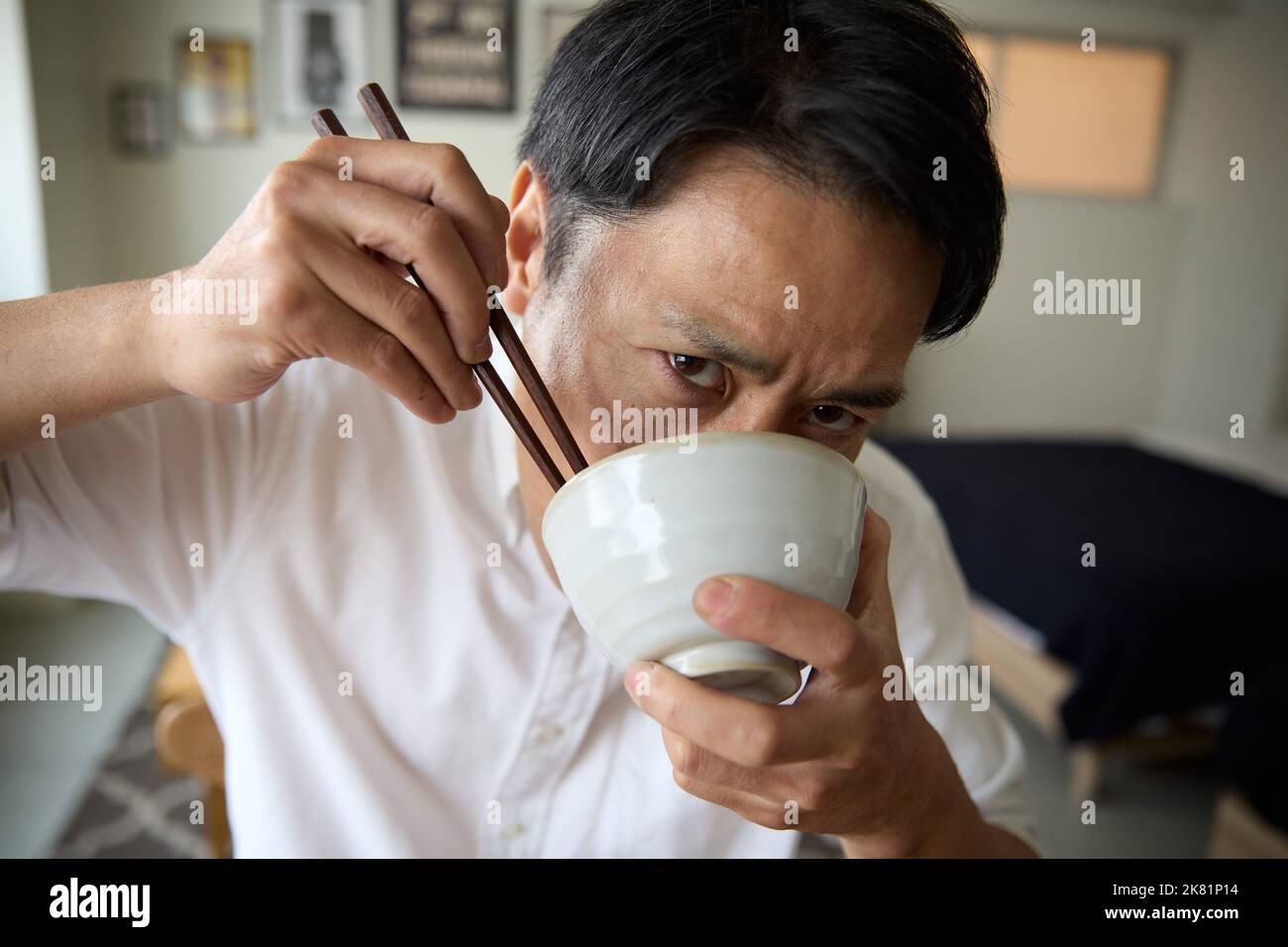 Japanese man eating meal in a hurry Stock Photo - Alamy