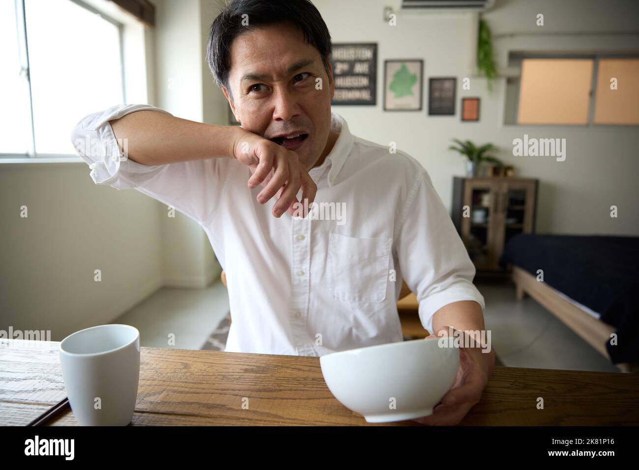 Japanese man eating meal in a hurry Stock Photo - Alamy