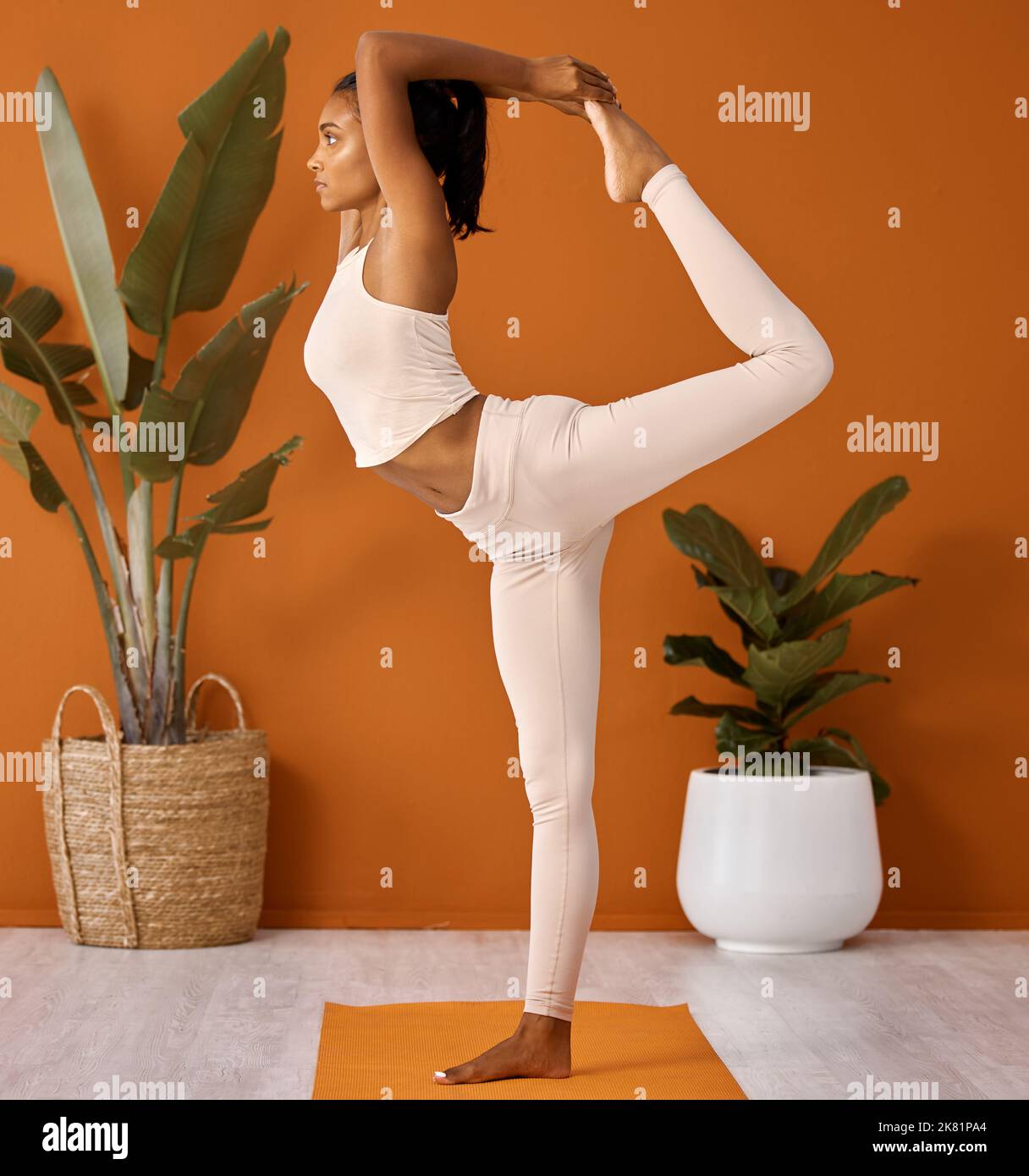 I aim to stay flexible. a young woman stretching shot against a studio ...