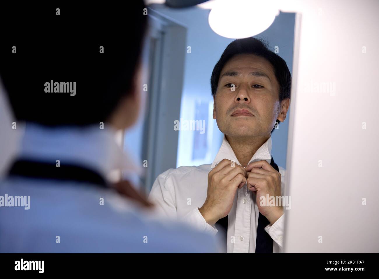 Japanese man tying a tie Stock Photo - Alamy