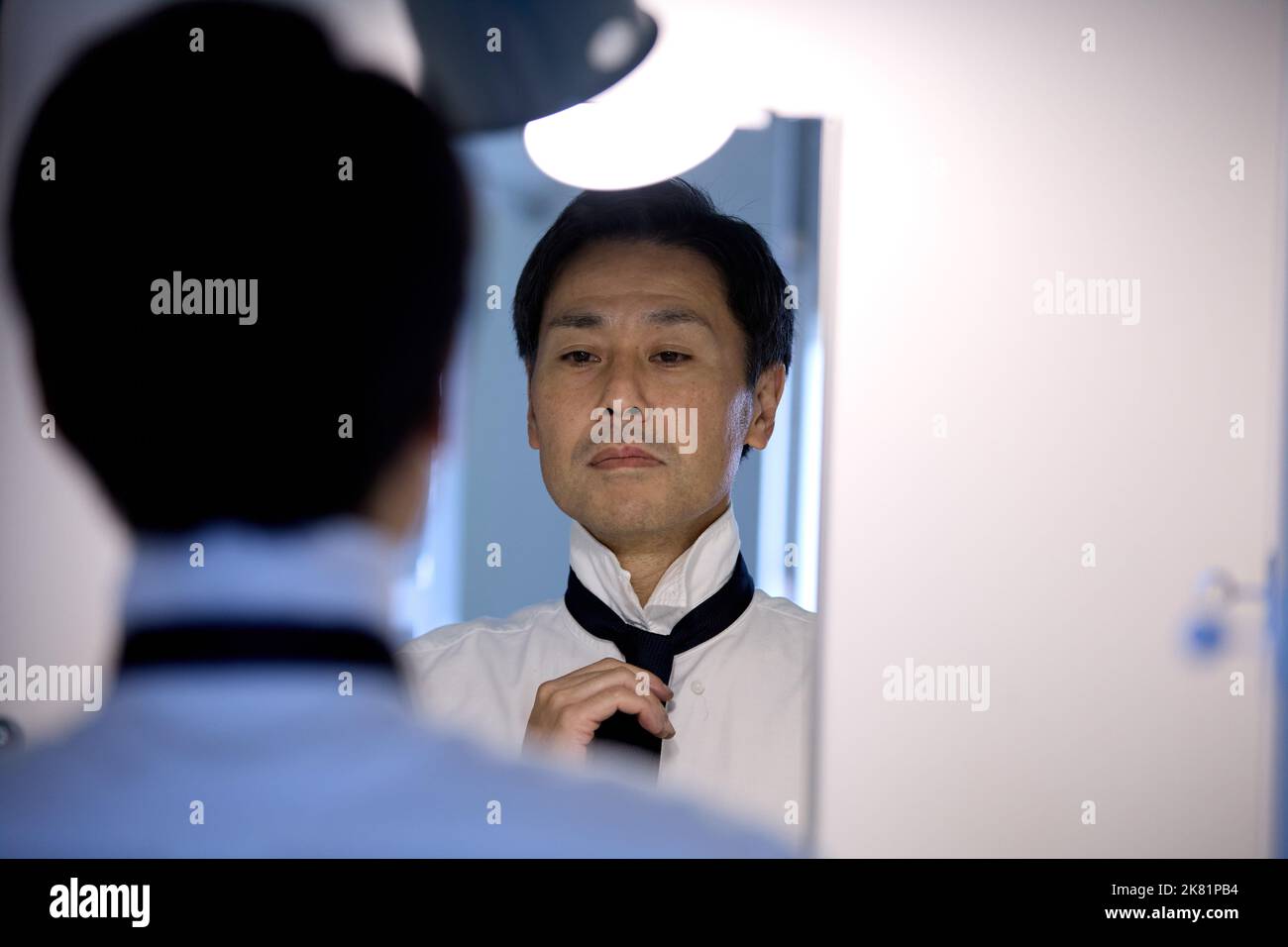 Japanese man tying a tie Stock Photo - Alamy