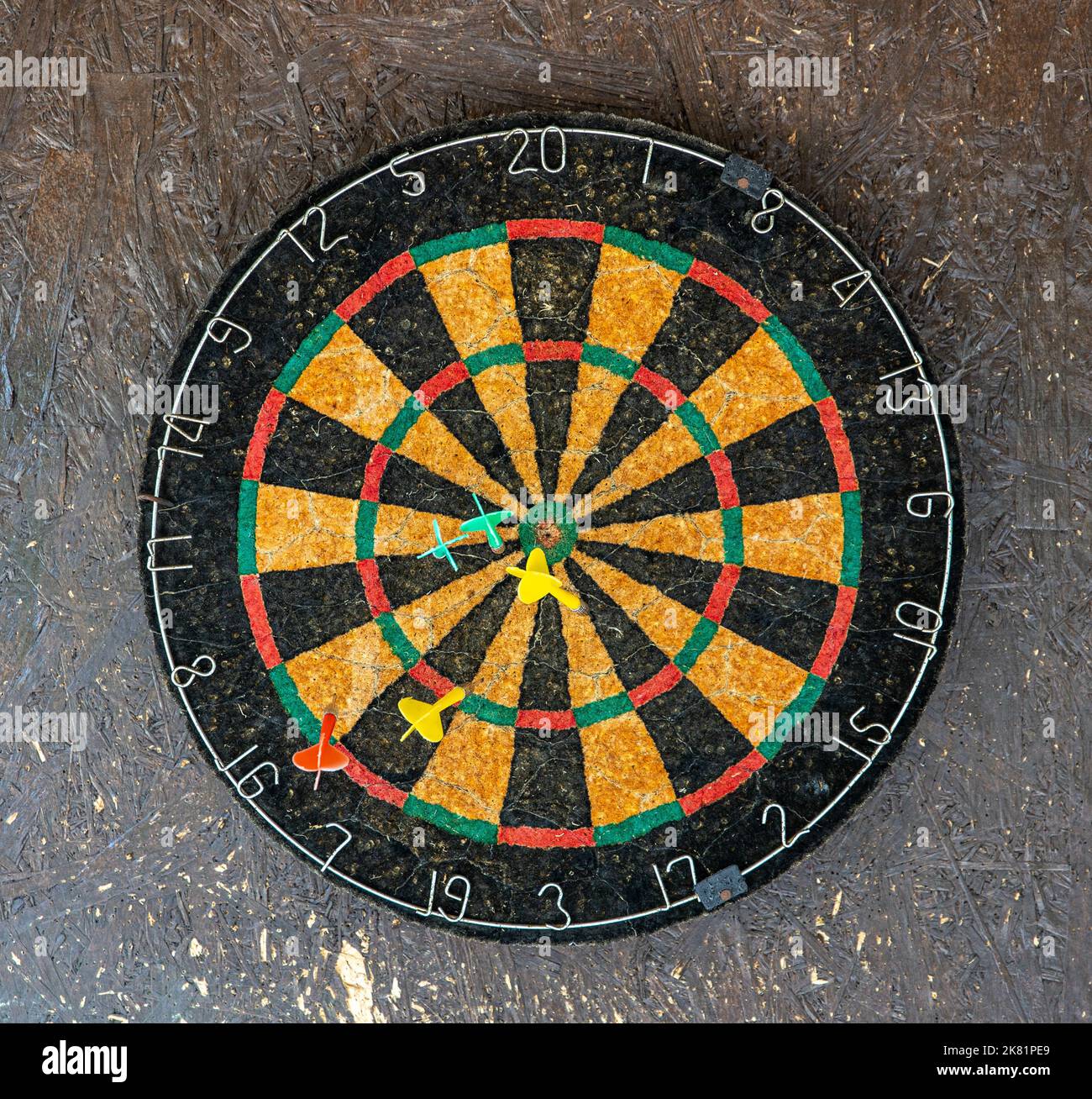 Dart board detail with darts on wall Stock Photo - Alamy