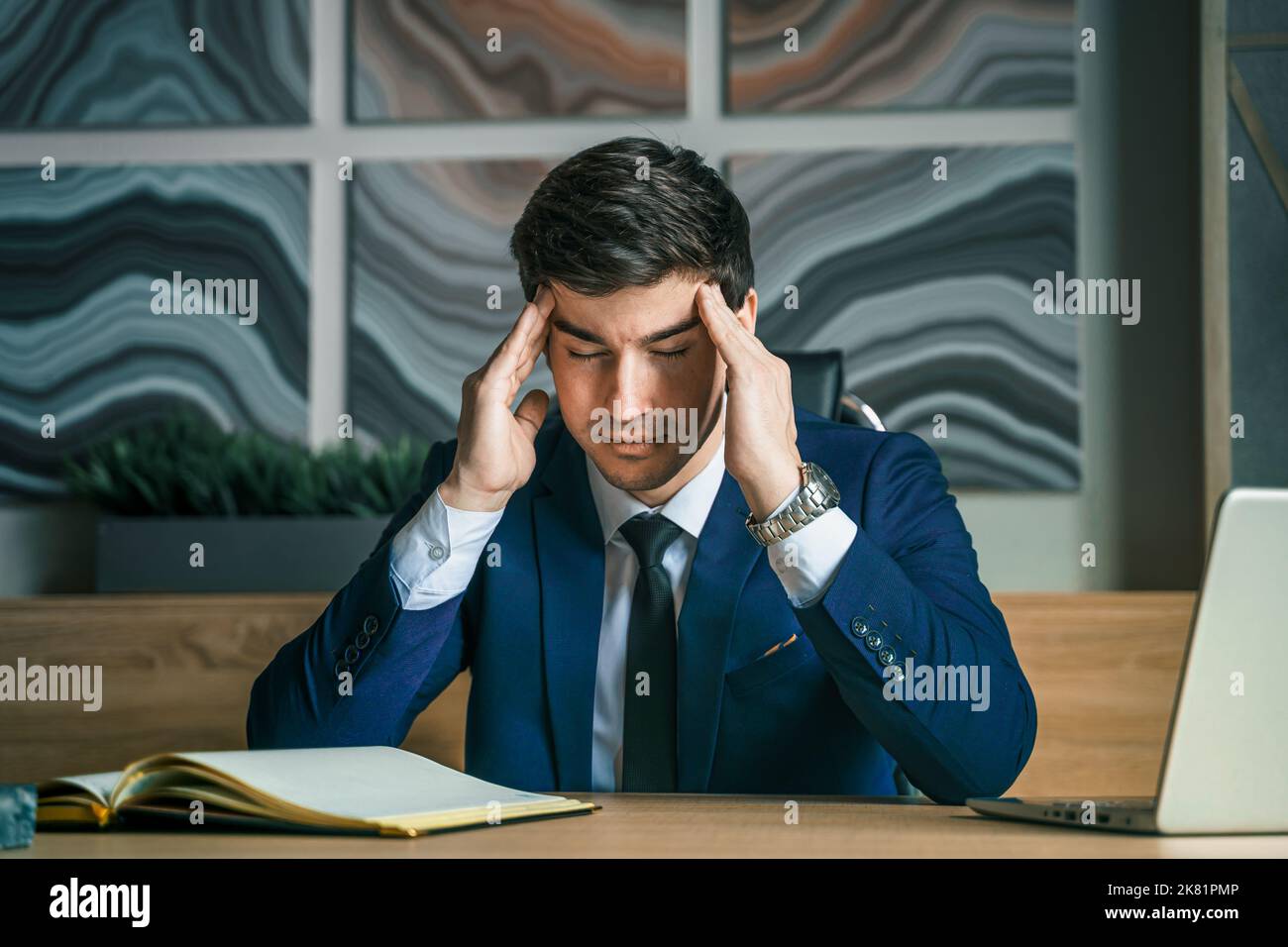 Stress and anxiety. Tired thinking businessman working with laptop in ...