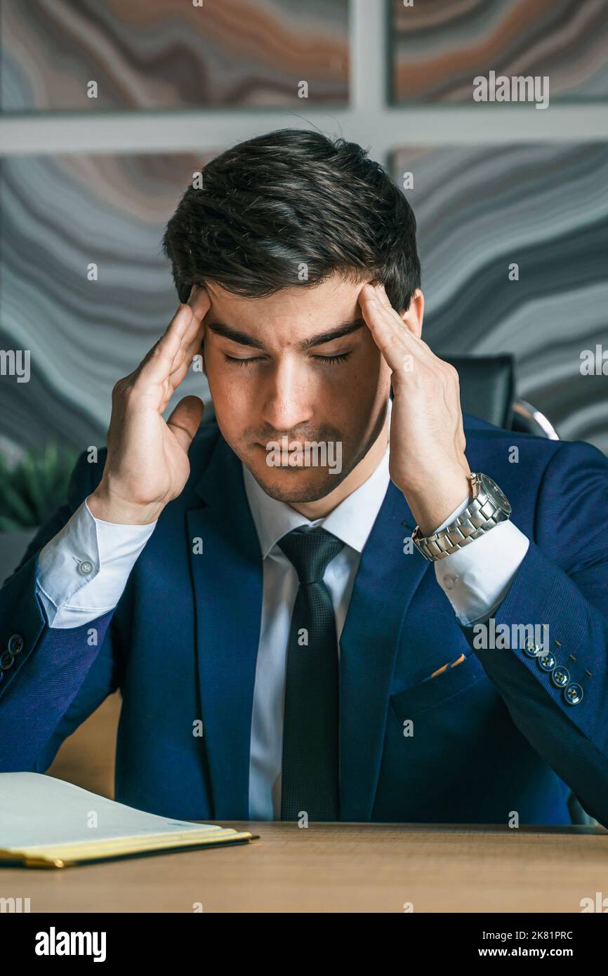 Stress and anxiety. Tired thinking businessman working with laptop in ...