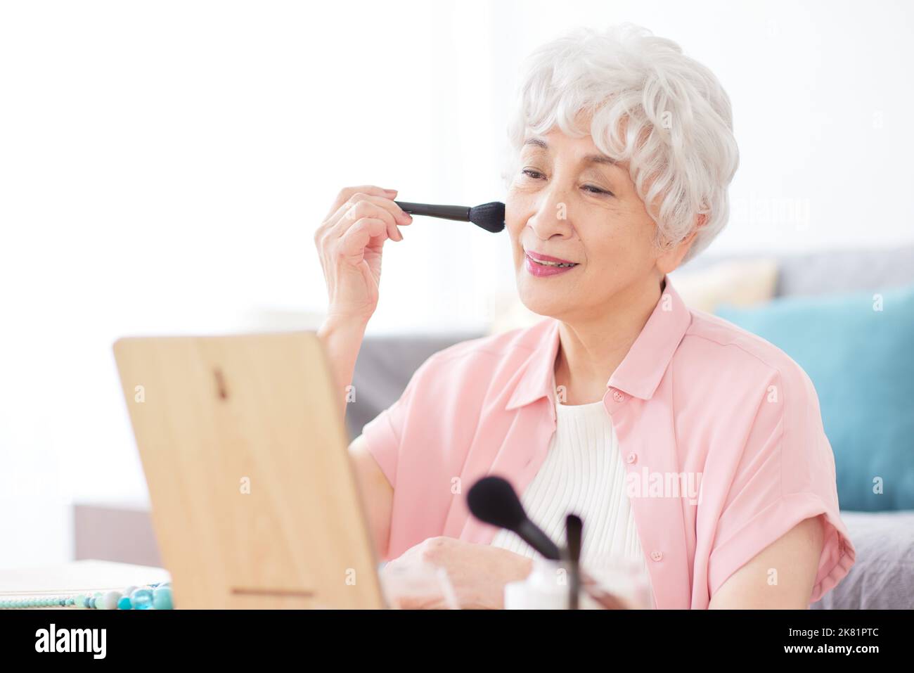Japanese senior woman applying makeup Stock Photo - Alamy