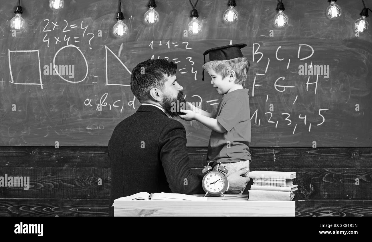 School break concept. Boy, child in graduate cap play with dad, having ...