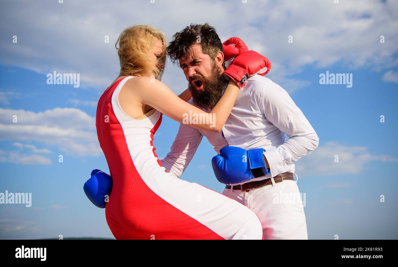 Learn how to defend yourself. Man and woman boxing gloves fight blue ...