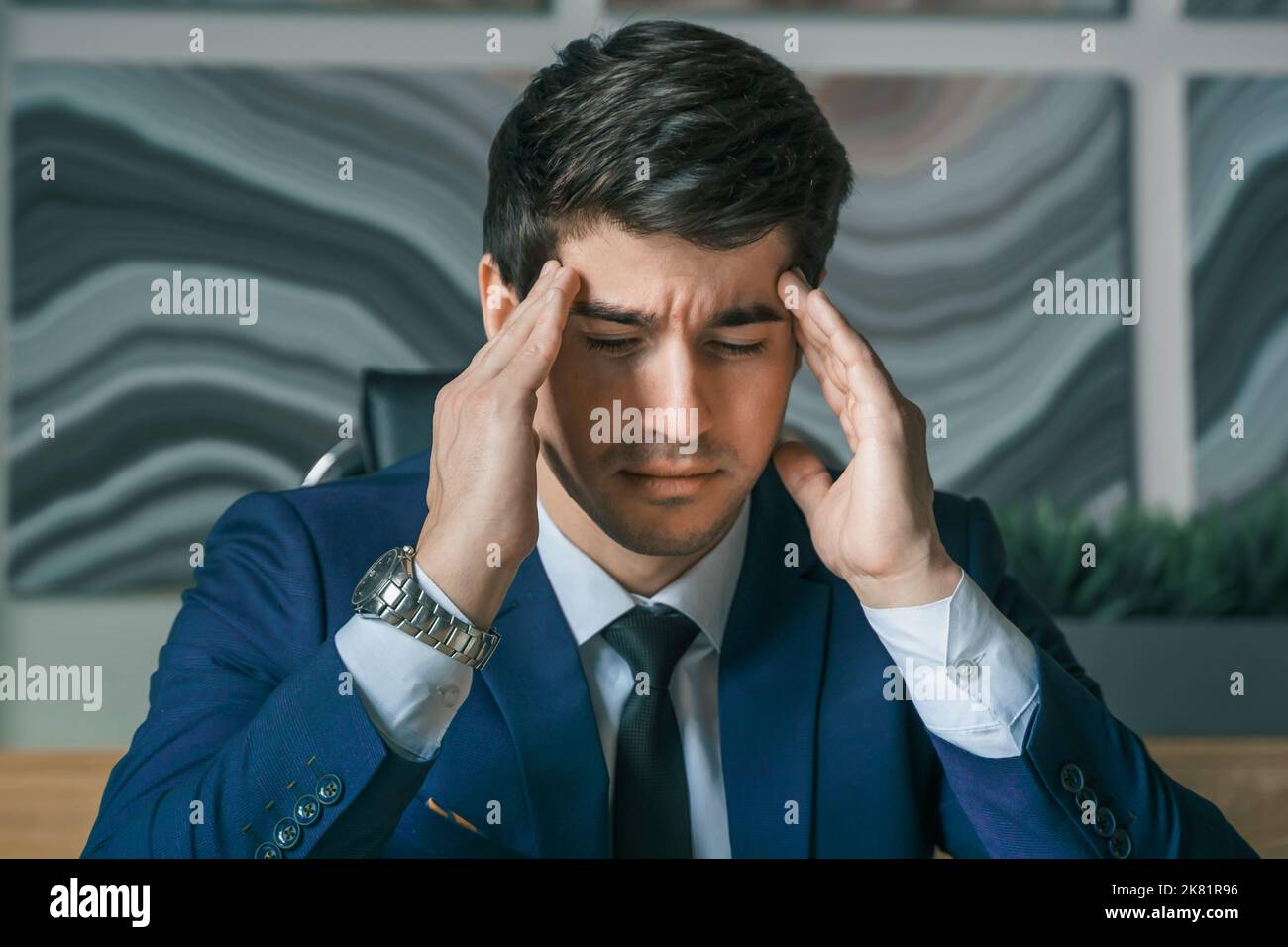 Stress and anxiety. Tired thinking businessman working with laptop in ...