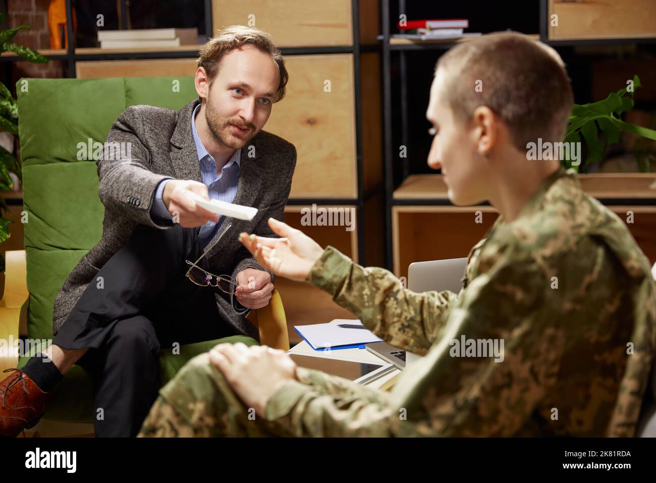 Military person having therapy session. Psychologist consults female ...