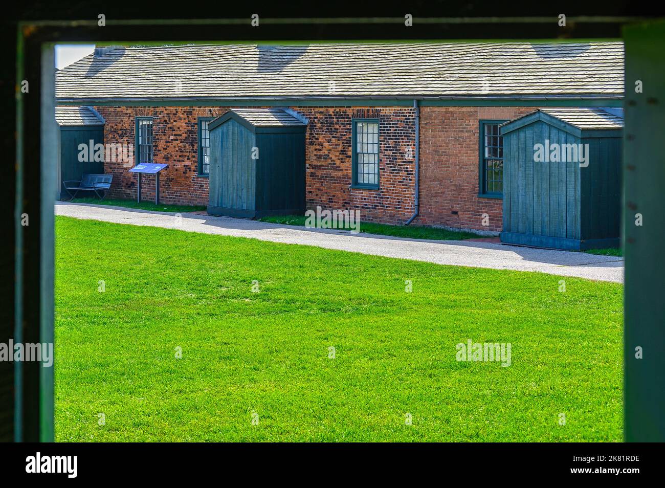 View of colonial brick wall building from inside of another ...