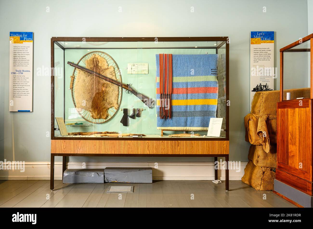 Exhibit explaining the trade with the First Nations. There is a gun, an ...