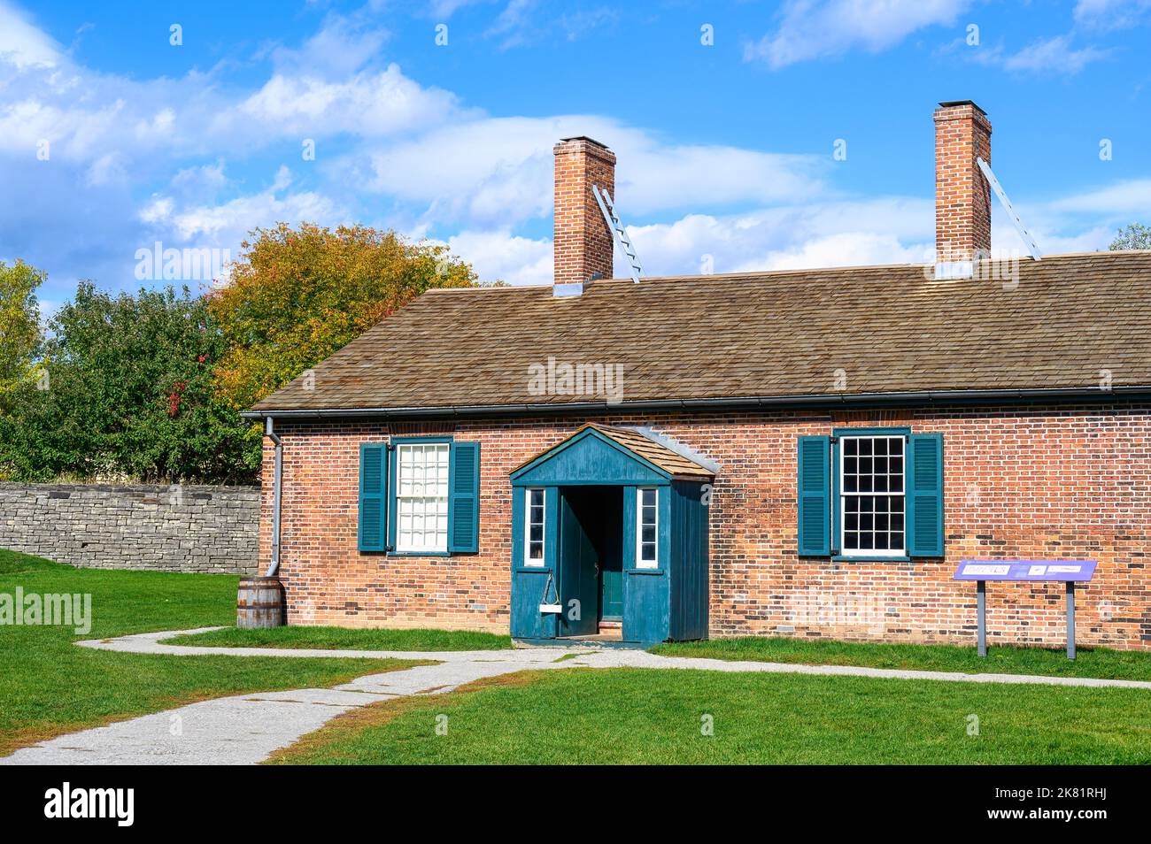 Facade of a colonial brick wall building with doors and windows. Fort ...