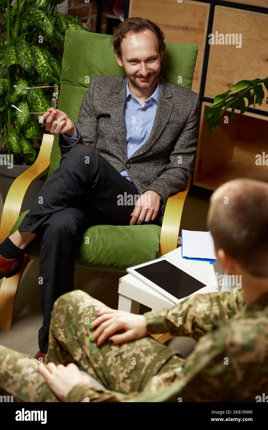 Military person having therapy session. Psychologist consults female ...