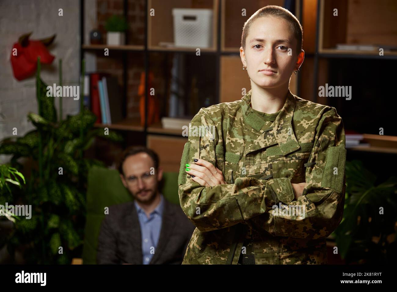 Portrait of female soldier attending meeting with psychologist. Pensive ...