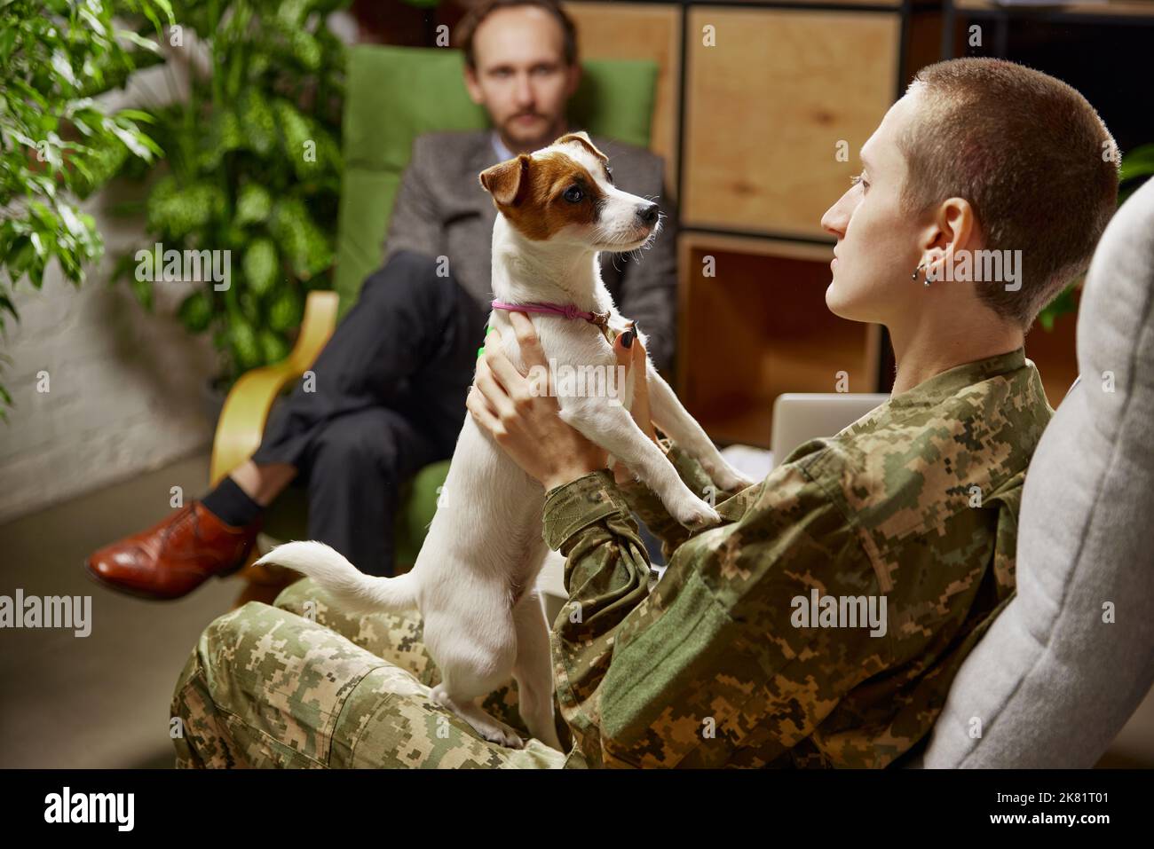 Two people, soldier in military uniform and psychologist at therapy ...