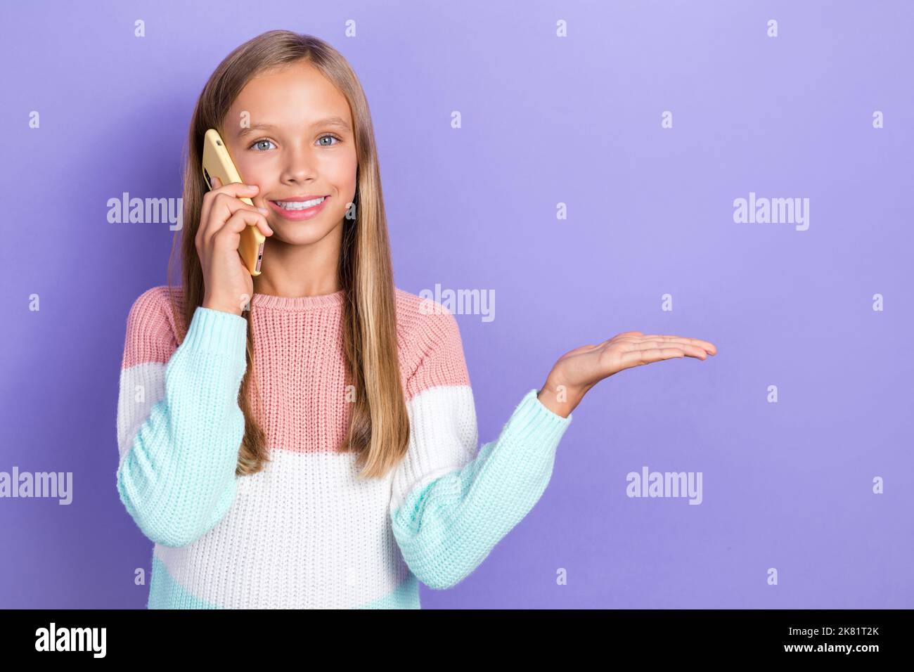 Photo of positive girl speak telephone device hand show empty space ...