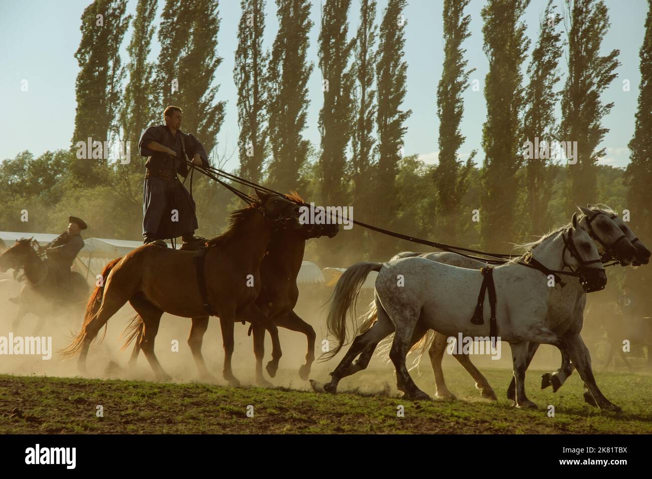 Hungarian horseman ride five horses. He wears the traditional Hungarian ...