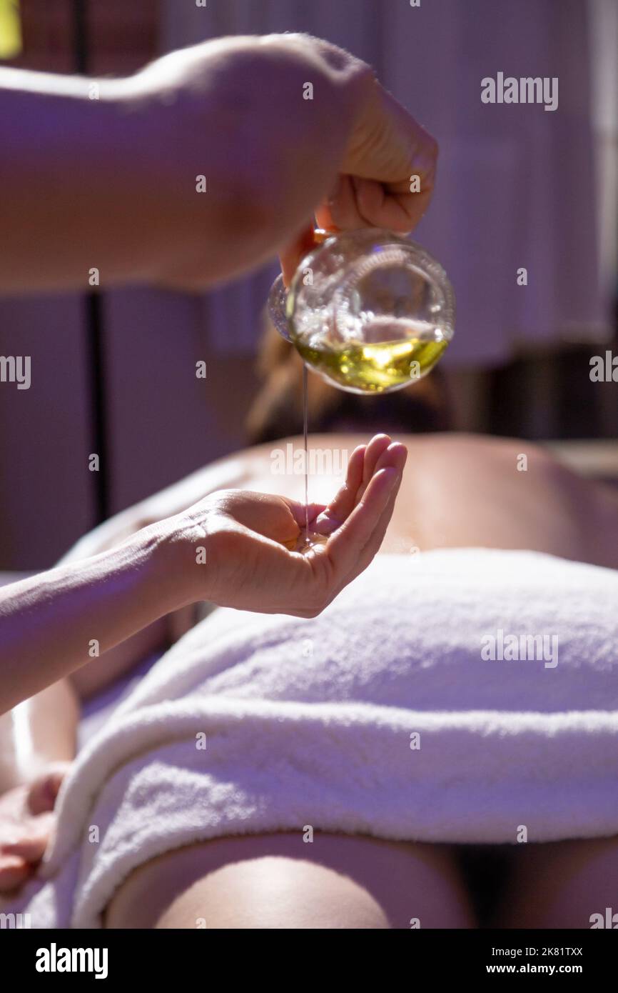 Goiânia, Goias, Brazil – October 01, 2022: Massage therapist pouring ...
