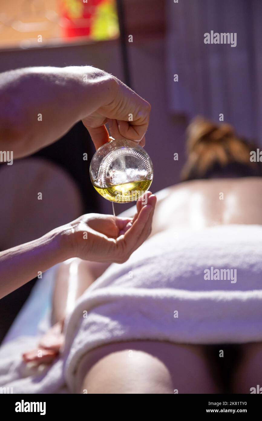 Goiânia, Goias, Brazil – October 01, 2022: Massage therapist pouring ...