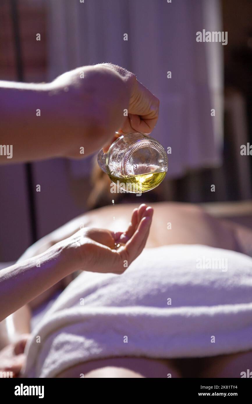 Goiânia, Goias, Brazil – October 01, 2022: Massage therapist pouring ...