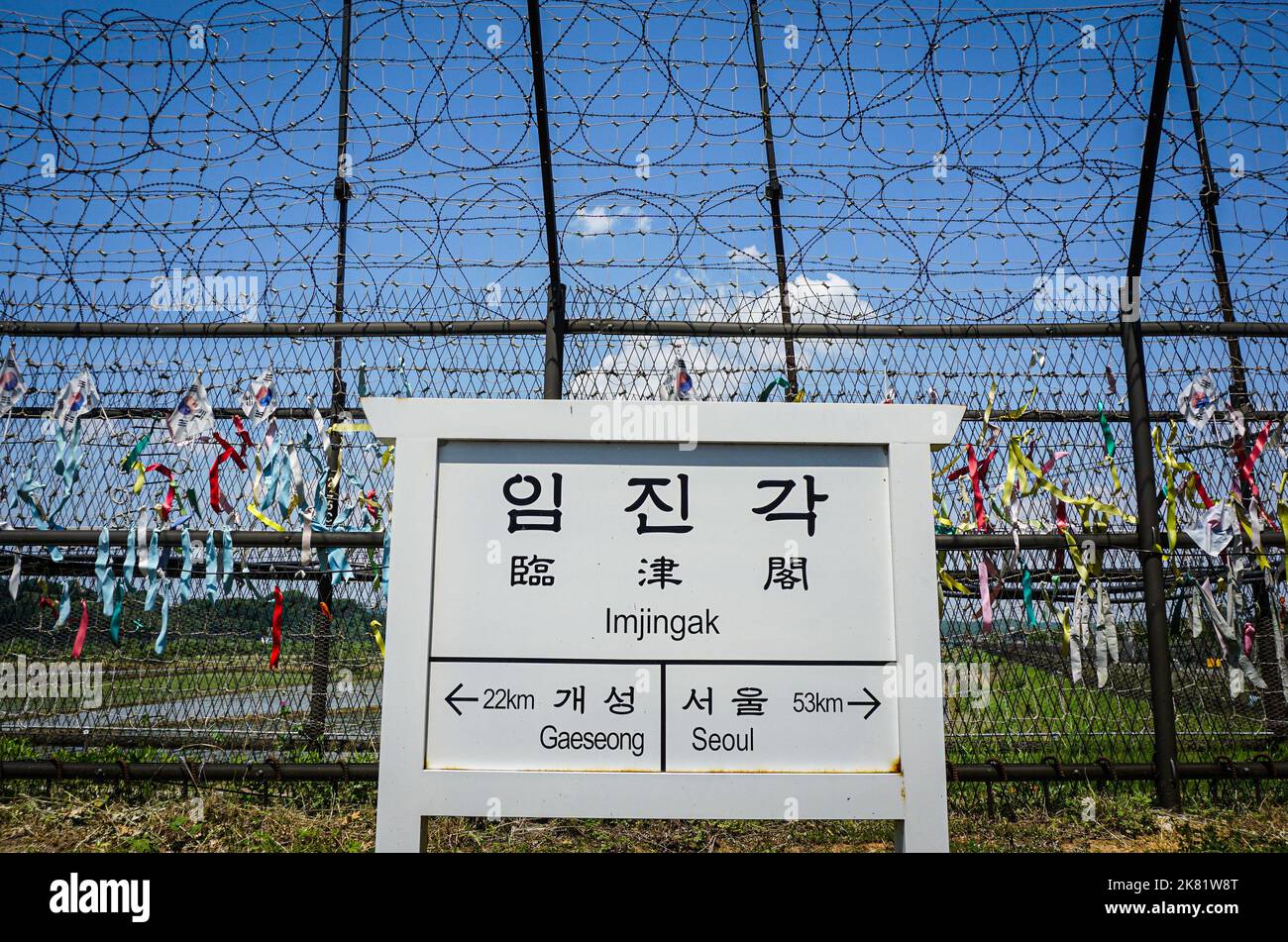South Korean flags and prayer ribbons are tied on the fence of the ...