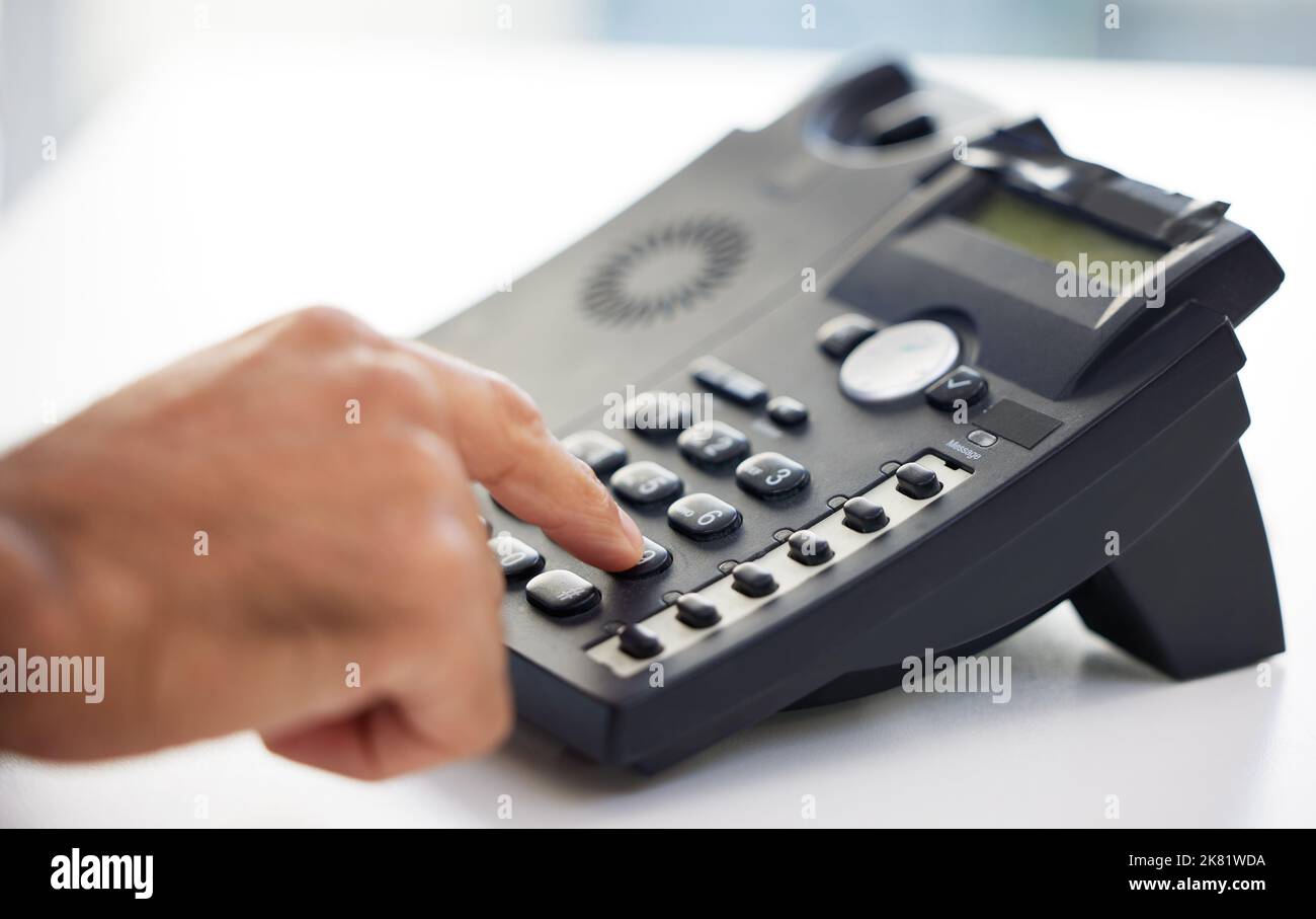 Always one dial away. an unrecognizable businessman dialling on a phone ...