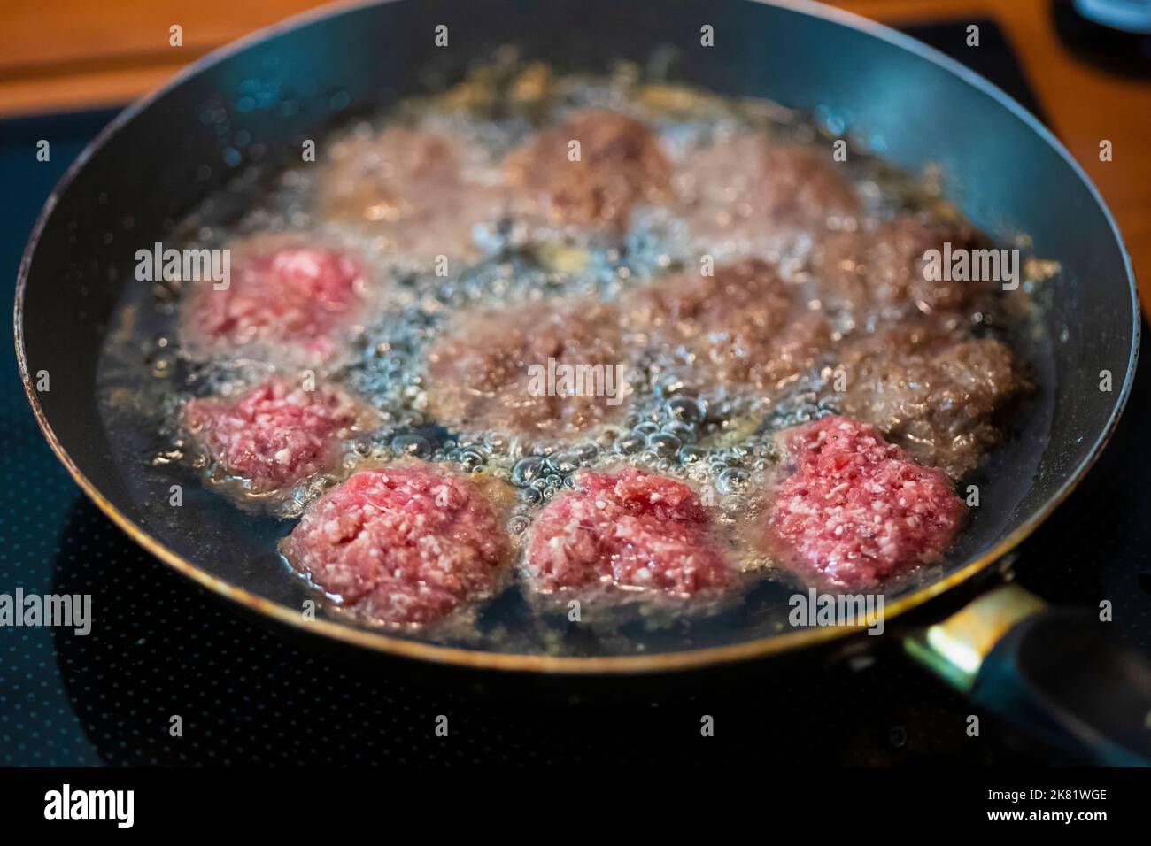 Frying beef meat balls in oil Stock Photo - Alamy