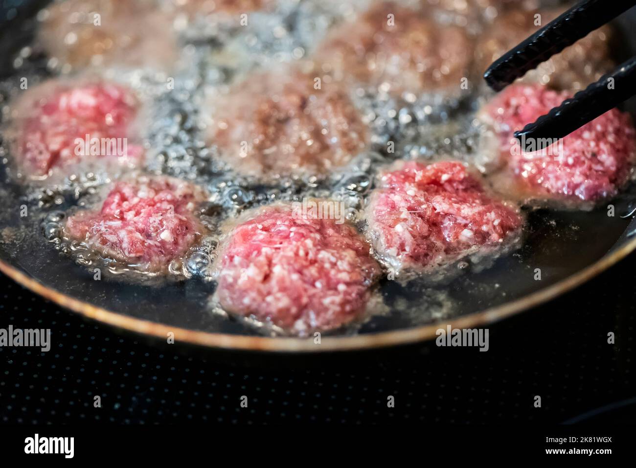 Frying beef meat balls in oil Stock Photo - Alamy