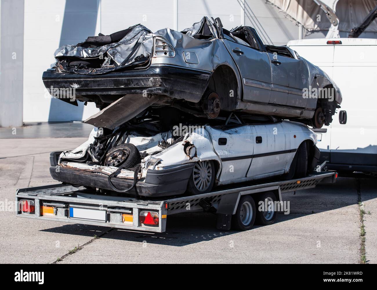 Two wrecked car on trailer Stock Photo - Alamy
