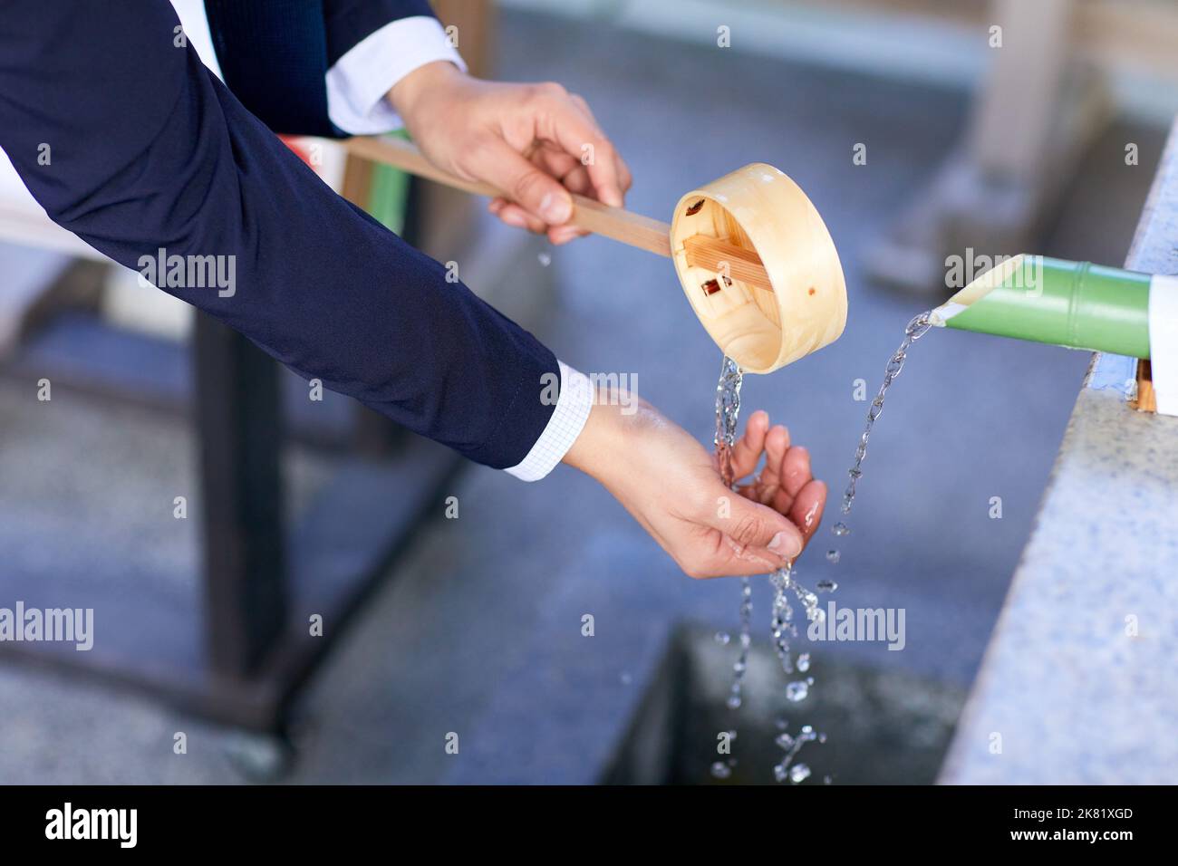 Japanese man washing hands at shrine purification fountain Stock Photo ...