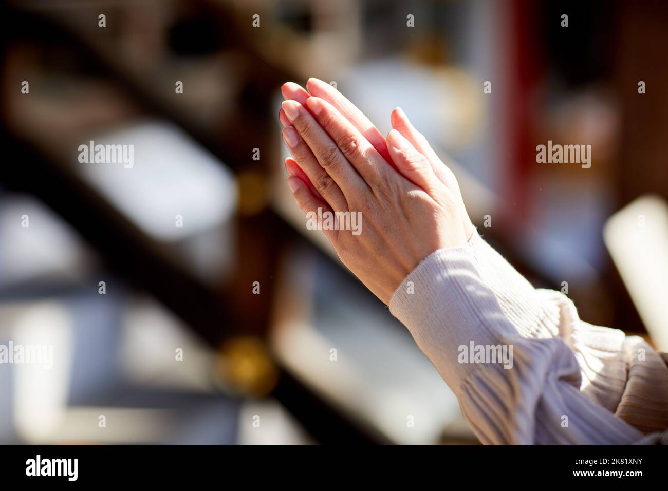 Japanese woman praying at the temple Stock Photo - Alamy