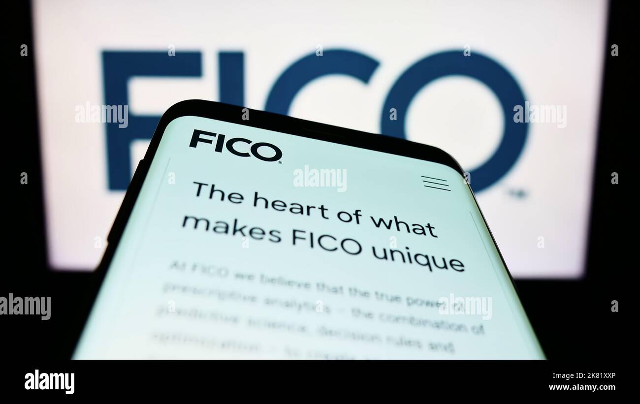 Mobile phone with website of US company Fair Isaac Corporation (FICO) on screen in front of ...