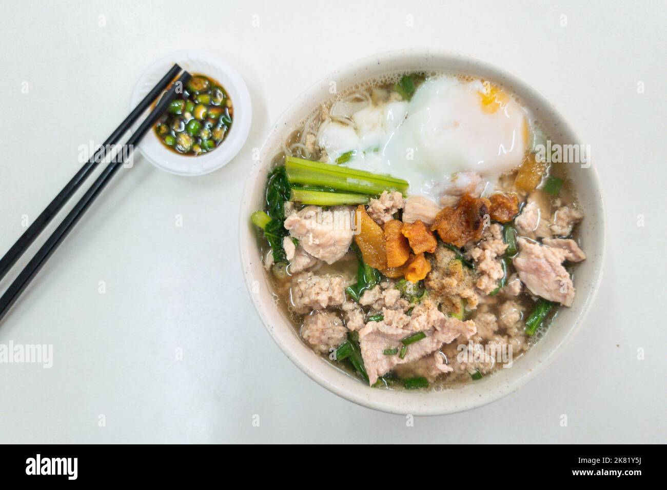 Overhead view of simple Chinese pork noodle soup with eggs served with ...