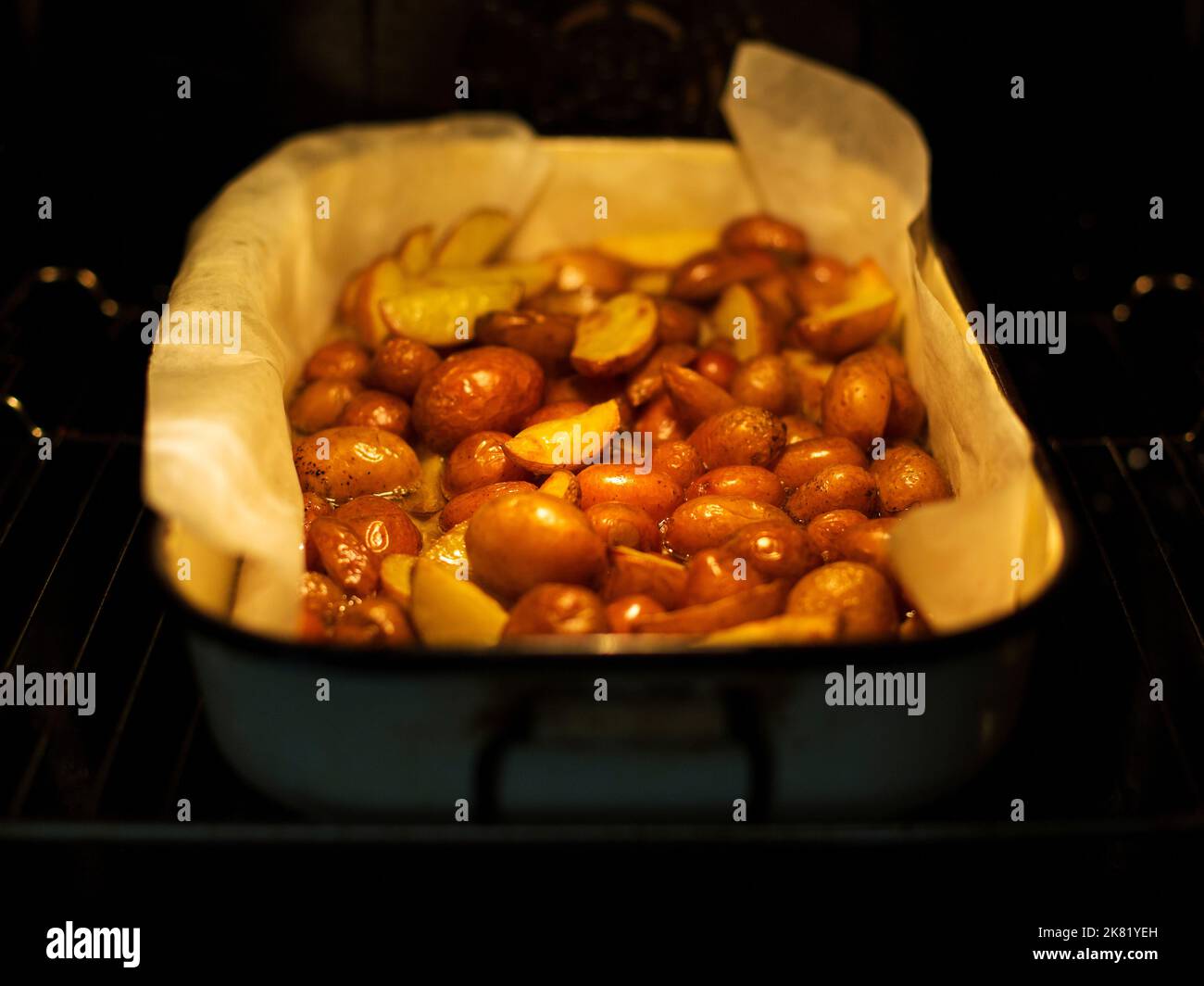 Potato froasted inside cooking oven in roasting dish Stock Photo - Alamy