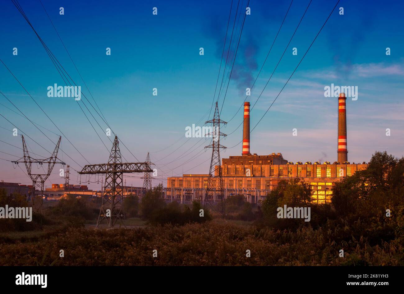 Power station with smoking chimney among electric wires Stock Photo - Alamy