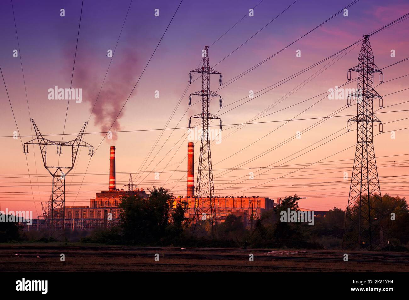 Power station with smoking chimney among electric wires Stock Photo - Alamy
