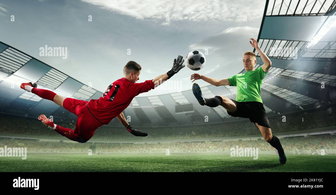 Scoring moment. Football goalkeeper in gates jumping to catching flying ...