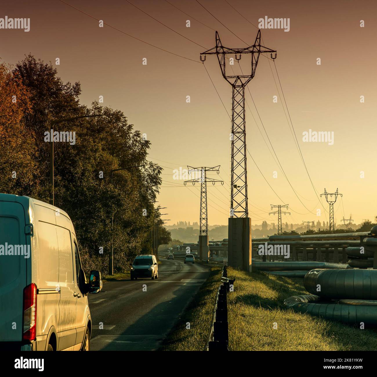 Electric wires and district heating tubes with road traffic Stock Photo ...