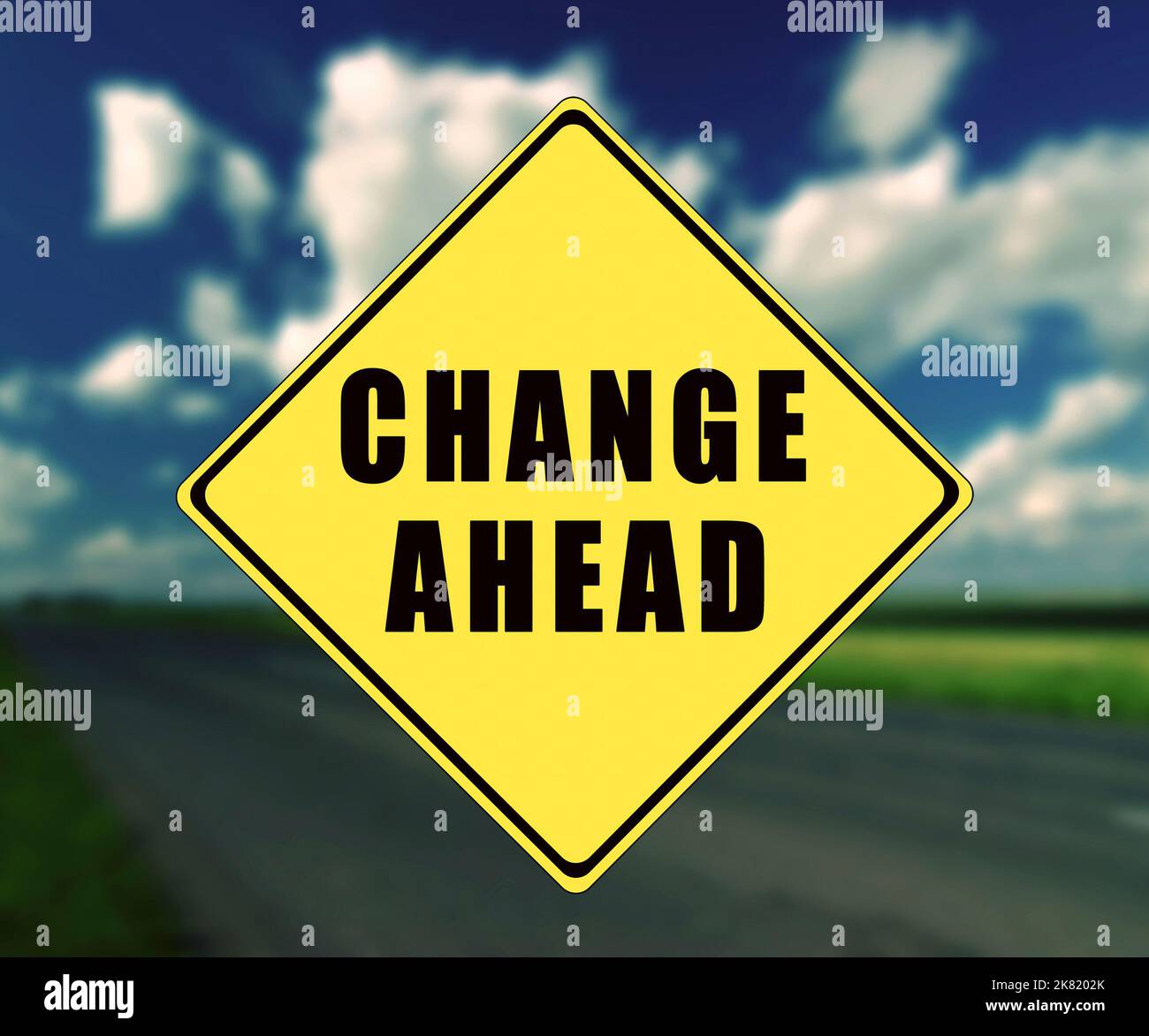 Road with yellow traffic sign change ahead text on it Stock Photo - Alamy