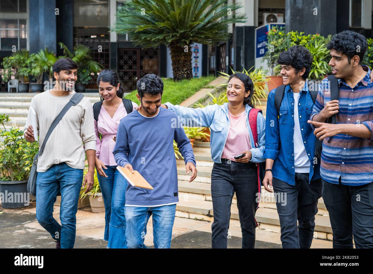 focus on girl, Group of students talking each other after class at ...