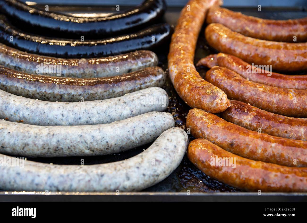 Traditional german street food - fried sausages in big frying pan Stock ...