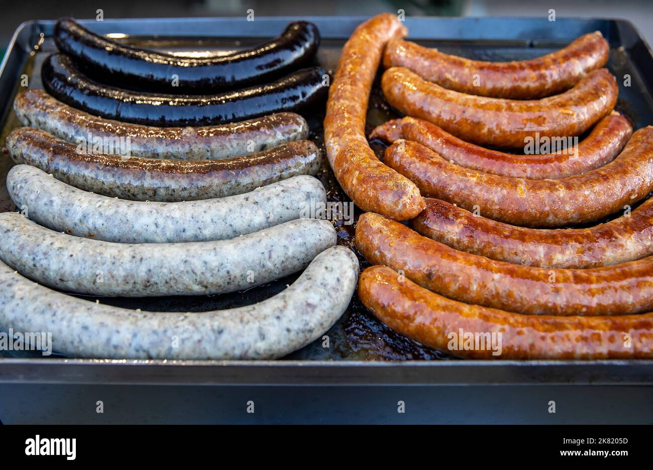 Traditional german street food - fried sausages in big frying pan Stock ...