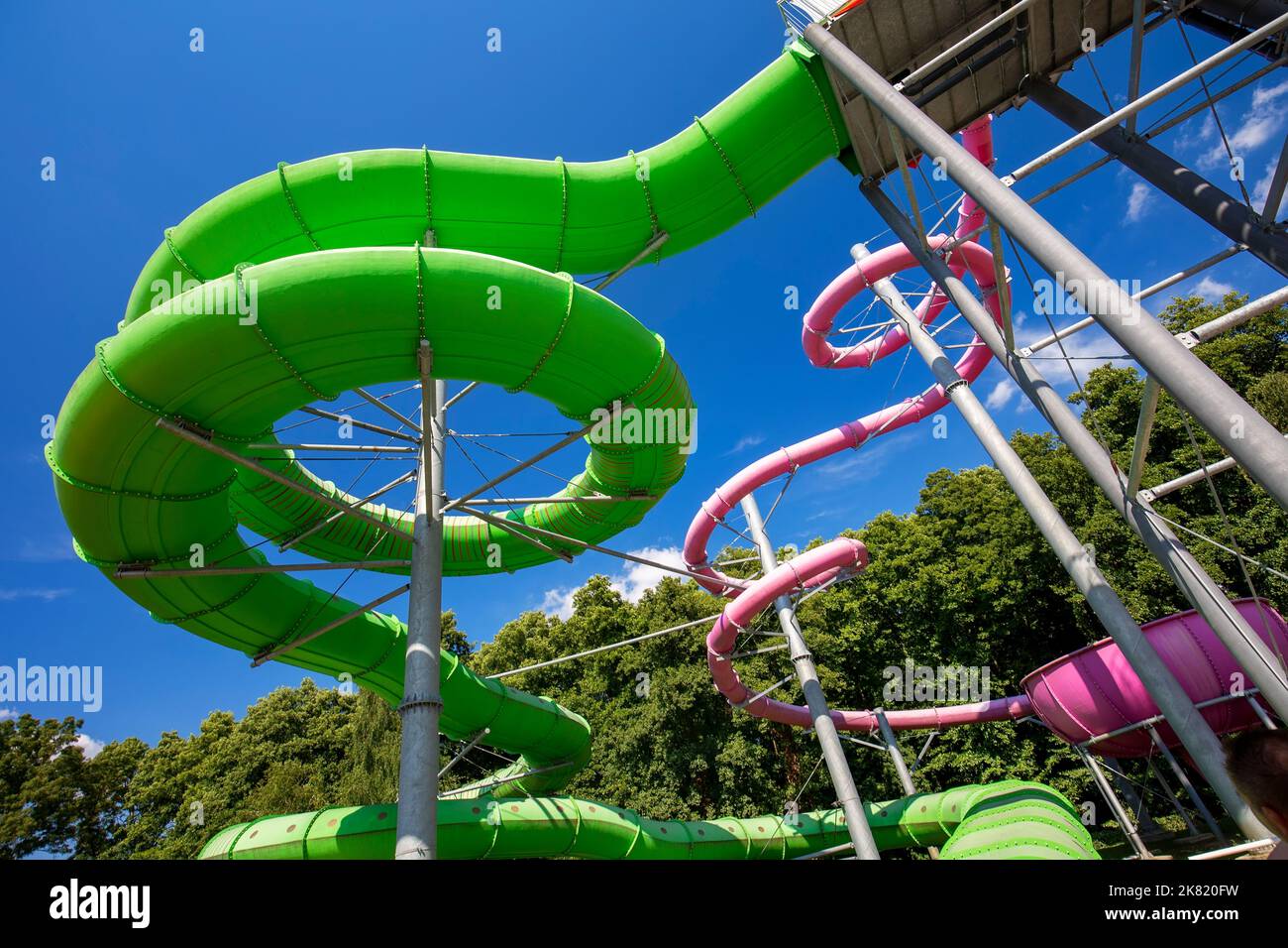 Yellow and green water slide in aquapark Stock Photo - Alamy