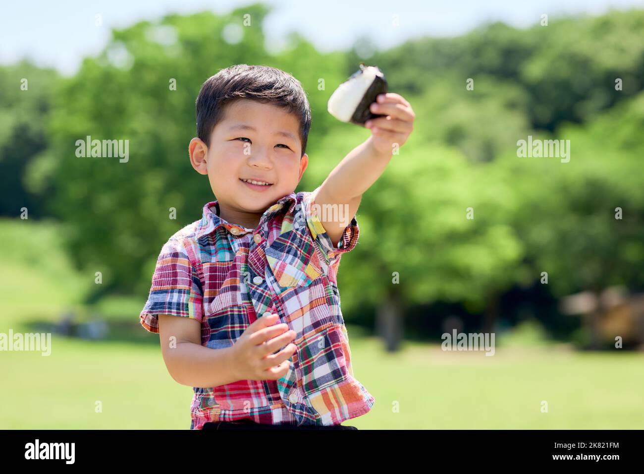 Boy eating rice ball hi-res stock photography and images - Alamy