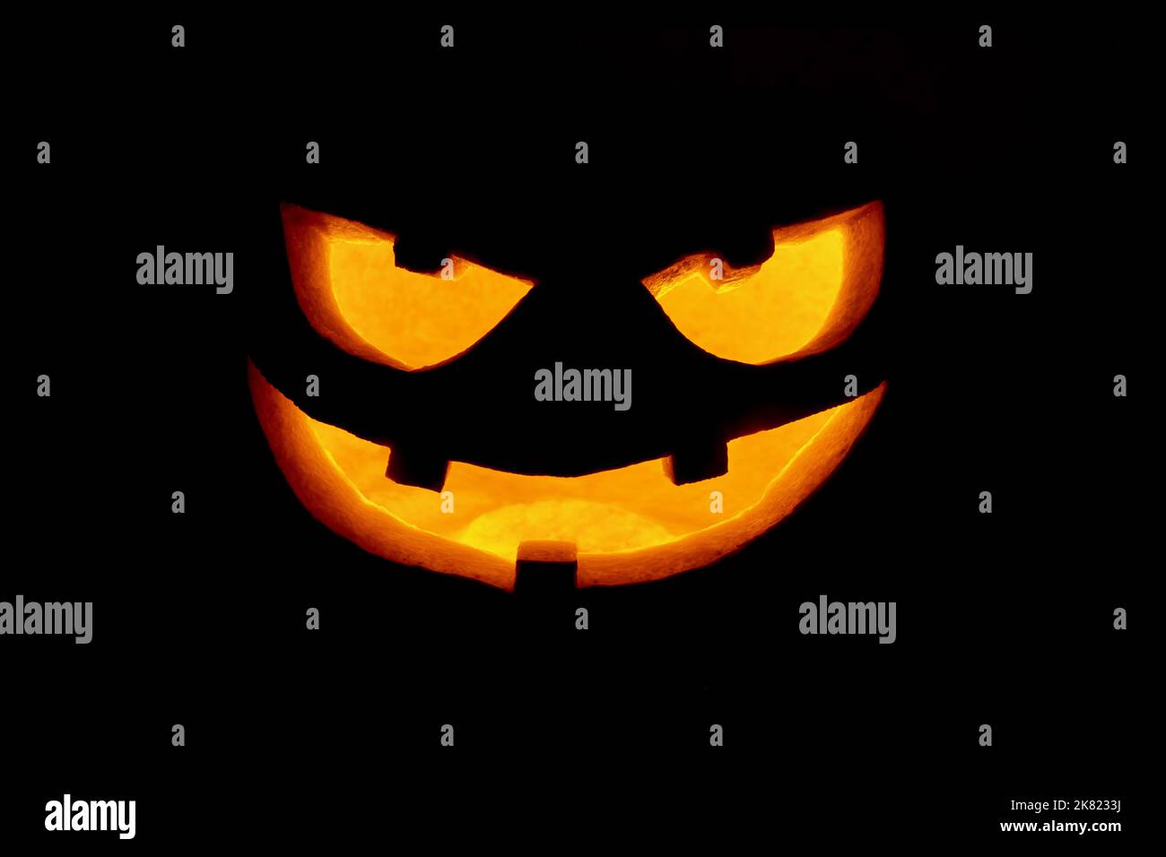 Traditional scary jack-o'-lantern smiling face glowing in the dark ...