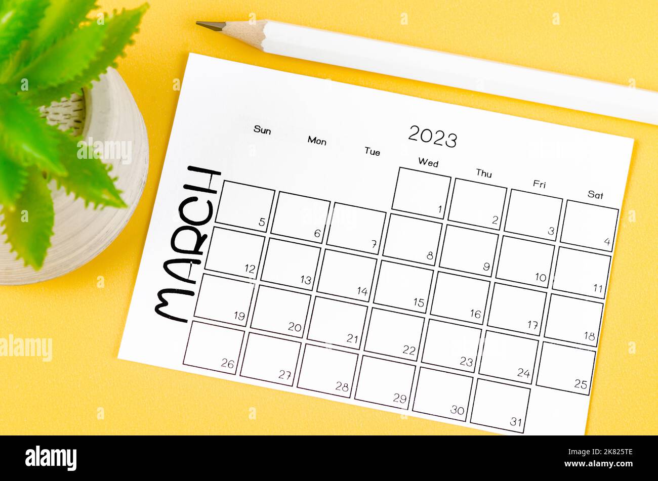 arch 2023 Monthly calendar for 2023 year with pencil on yellow ...